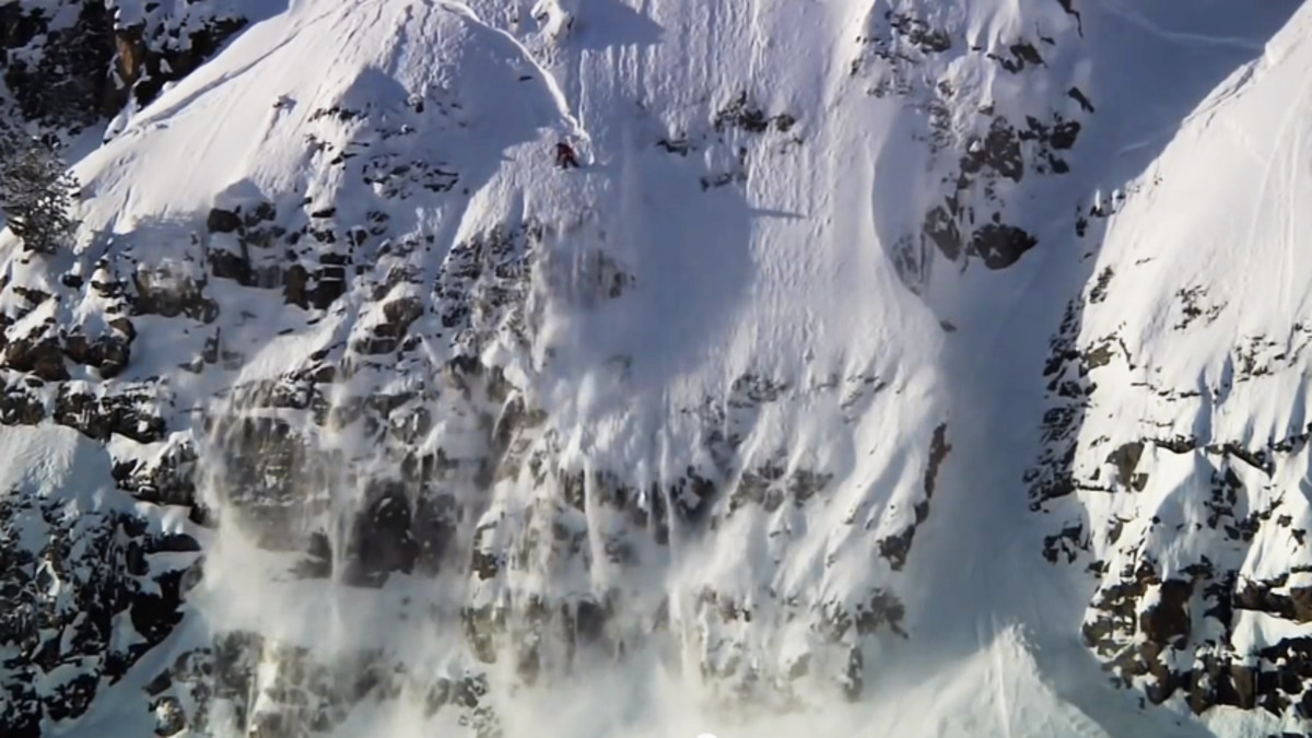 Nick Ennen huge cliff drop in Montana 80-100 feet - Snowboarder