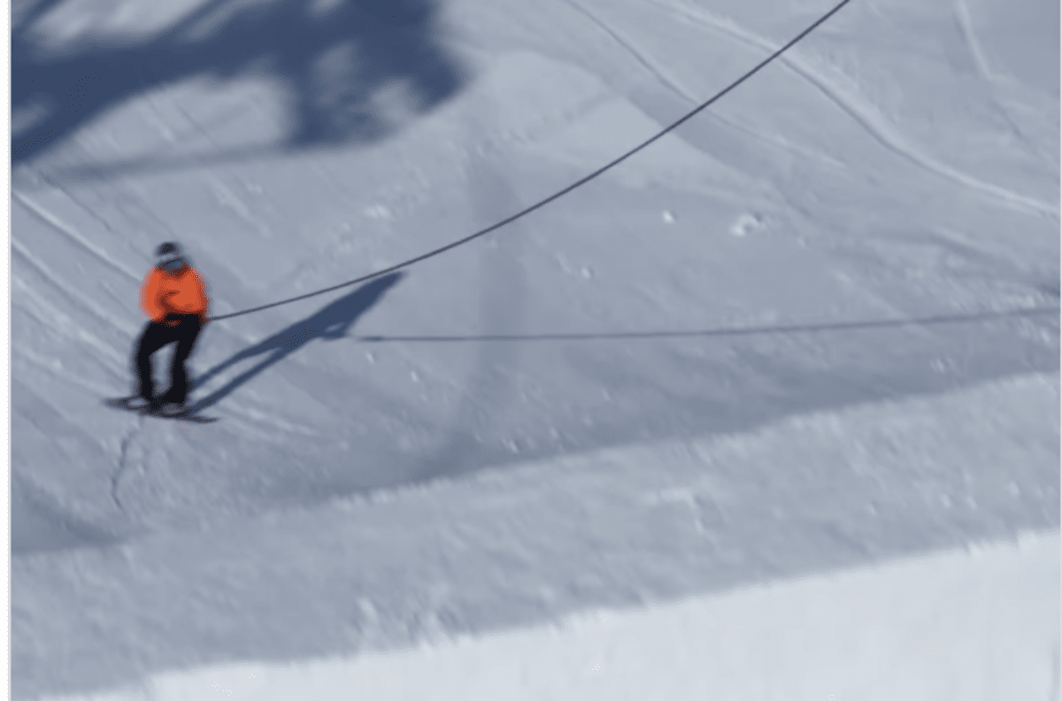 Watch This Snowboarder Ride Through the Resort Attached To a Helicopter